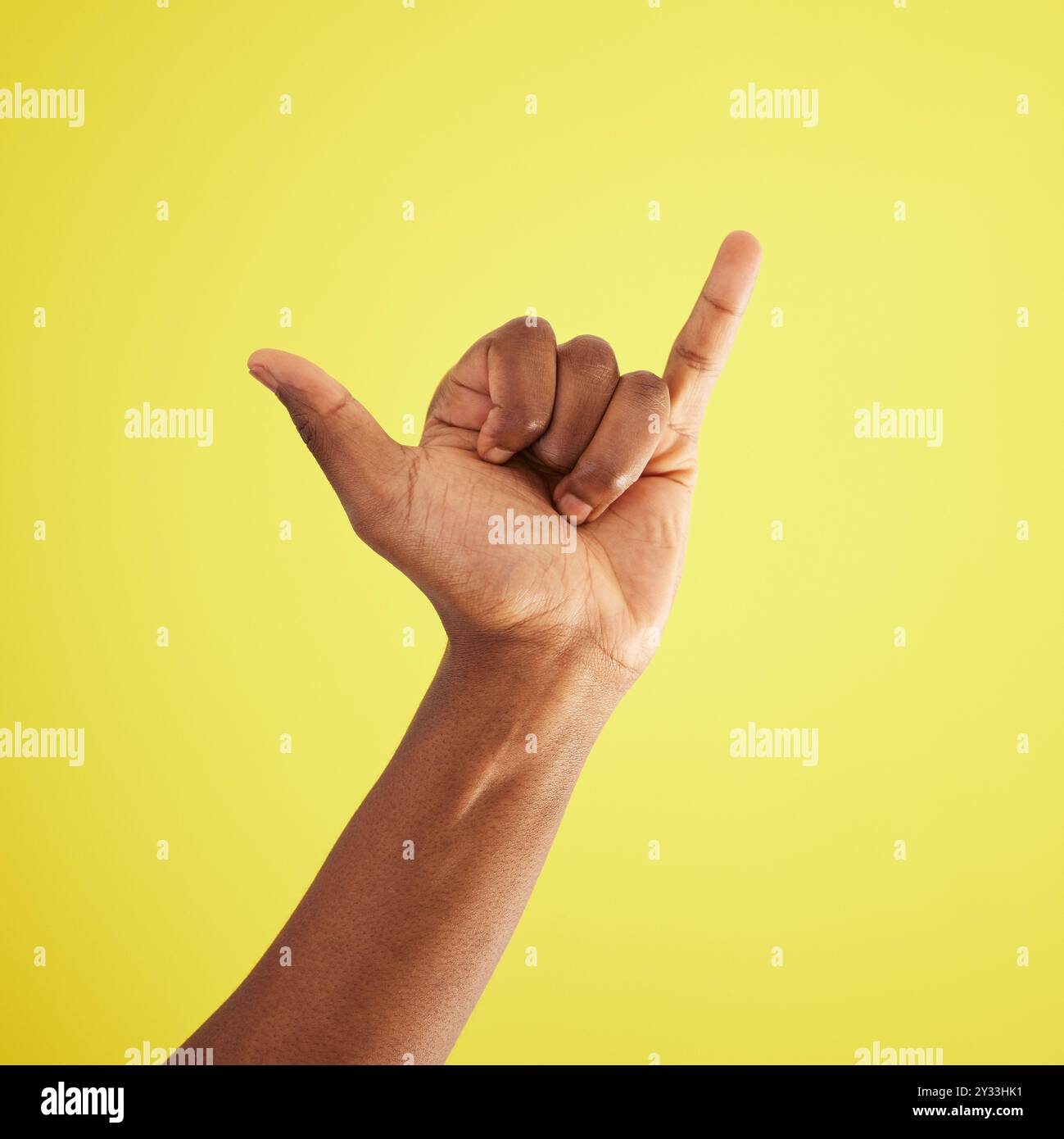 Hand, gesture and shaka with person in studio on yellow background ...