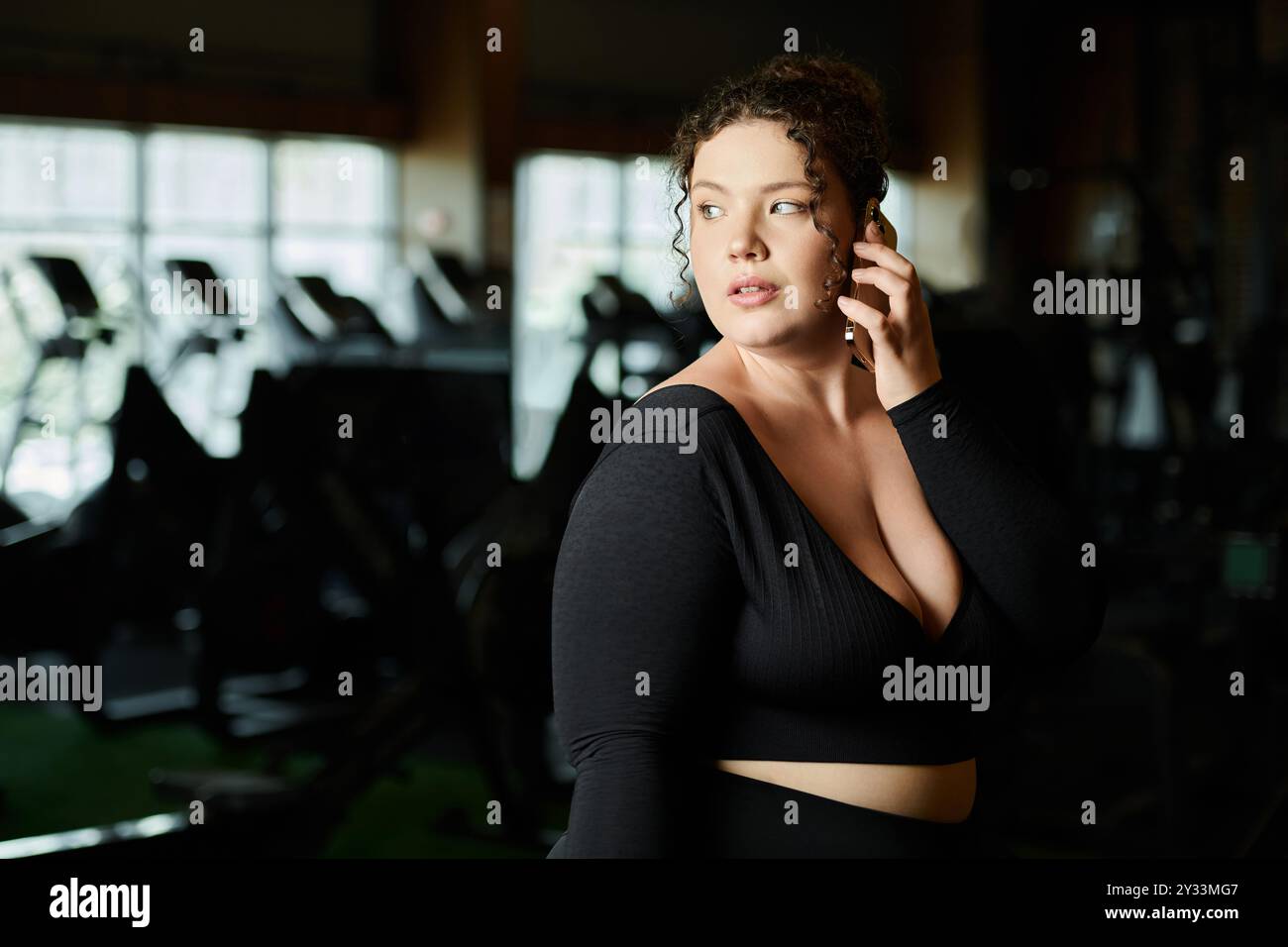A plus-size woman embraces her strength while working out in stylish ...