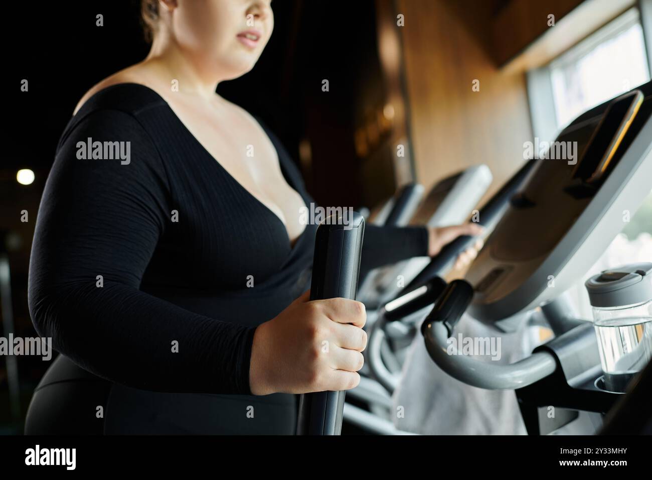 A plus-size woman engages in a workout, embodying body positivity and ...