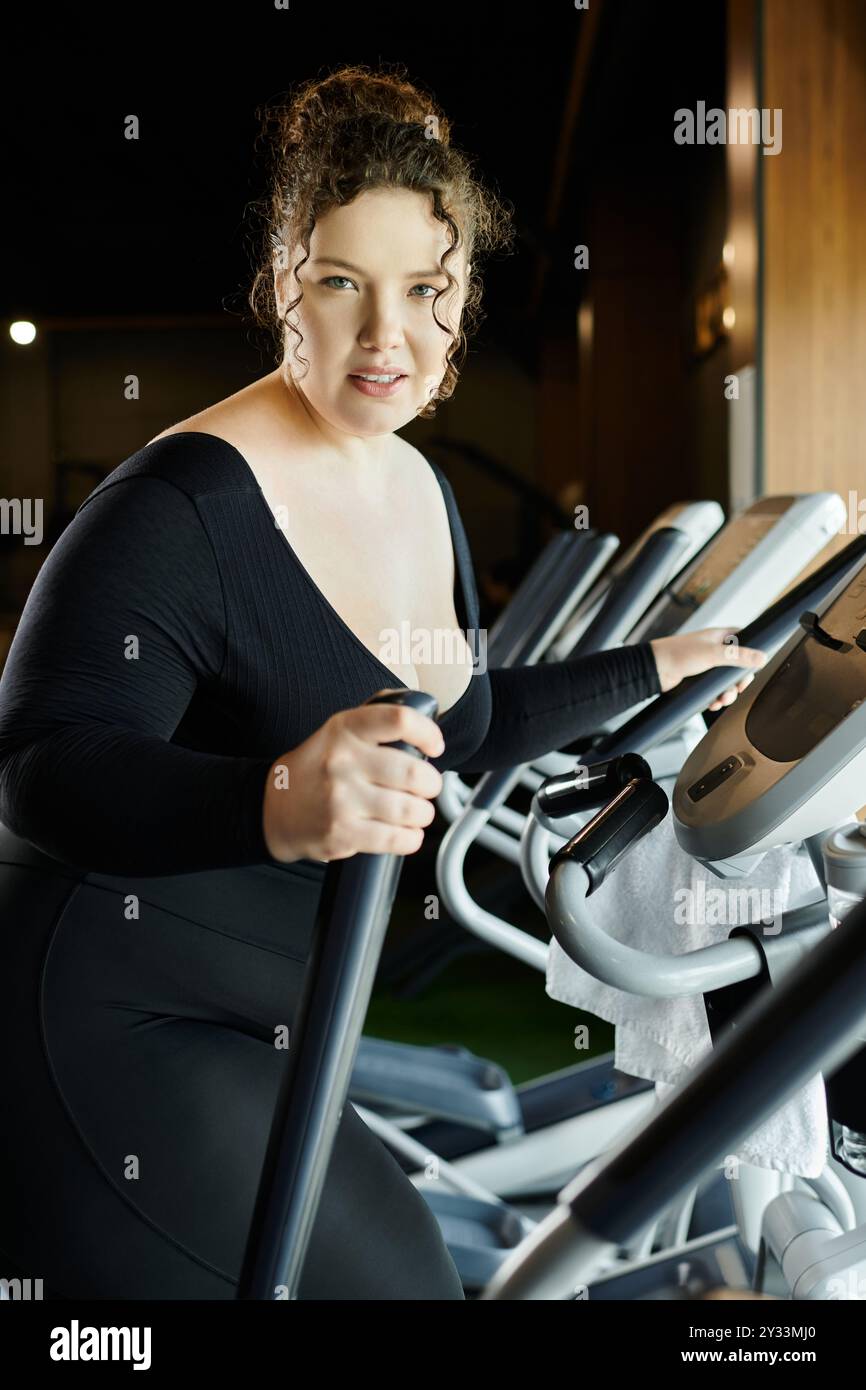 A confident young woman exercises on a gym machine, promoting body ...