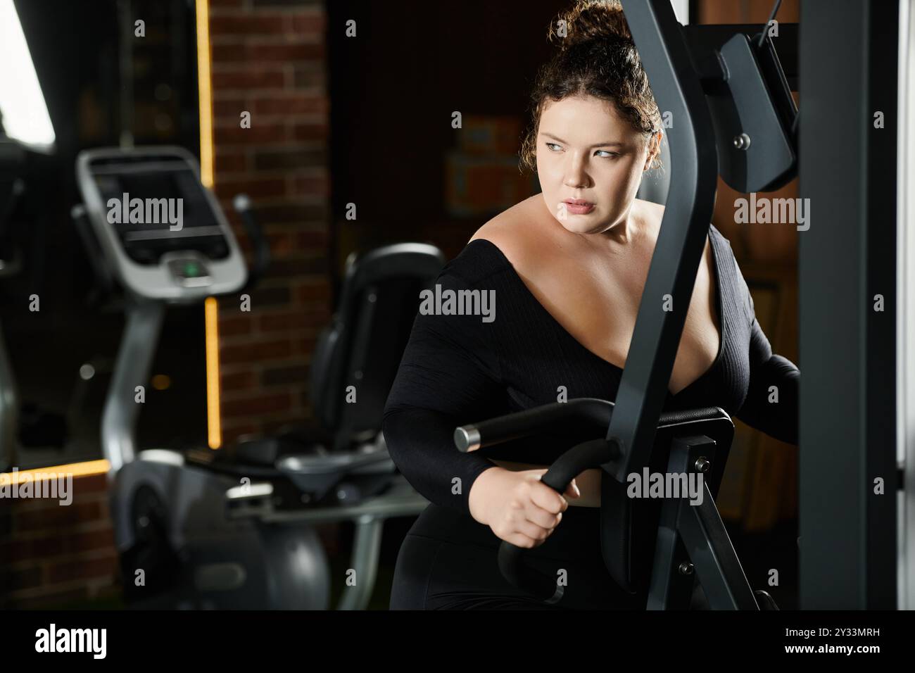 A young woman embraces body positivity while exercising in stylish ...