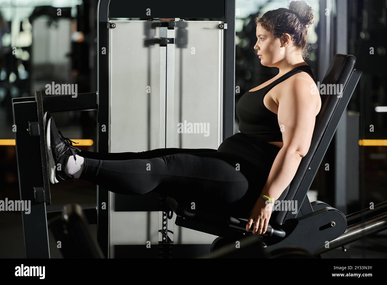 A plus size woman exercises confidently in a gym, embracing body ...