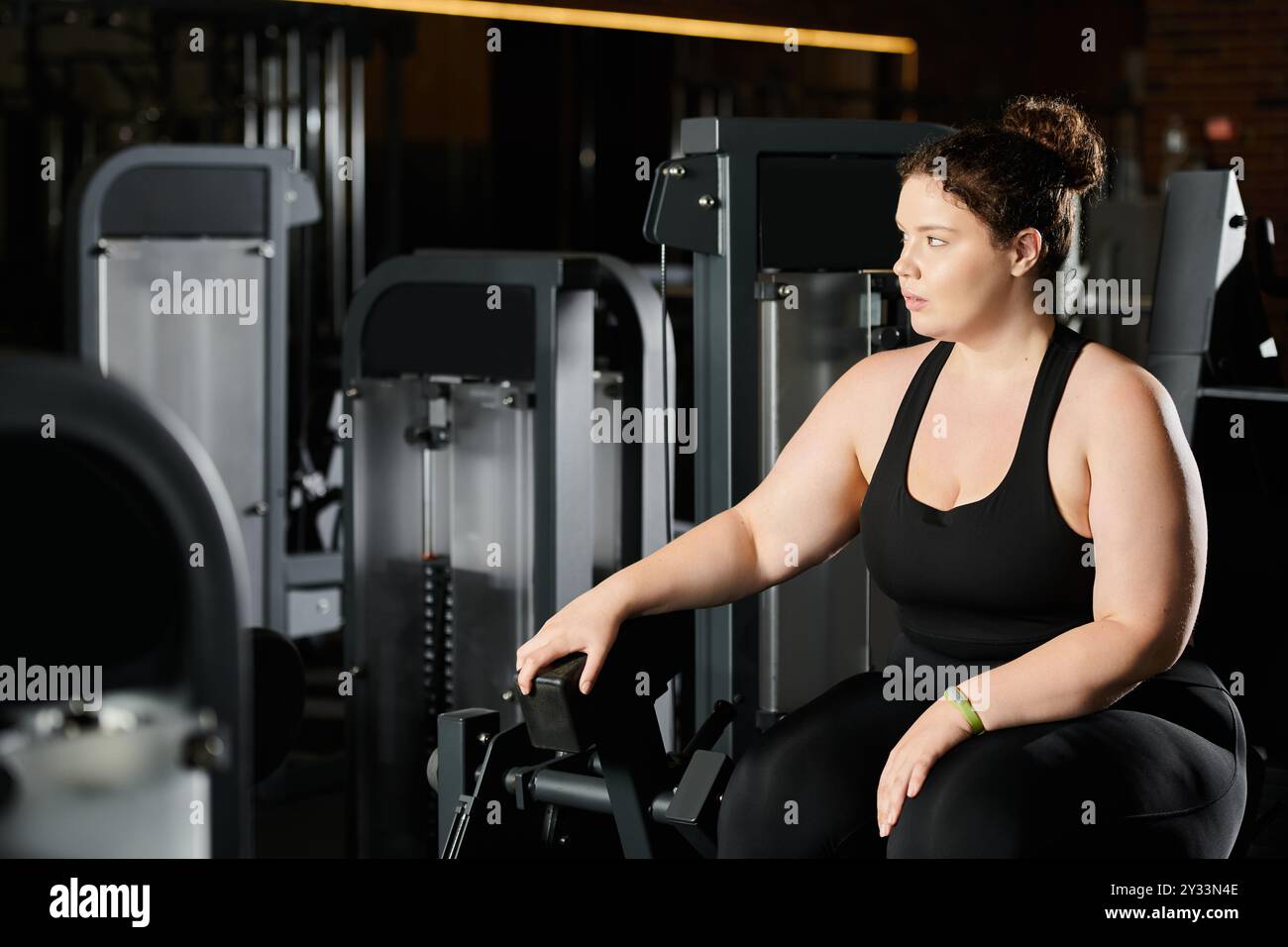 A plus-size woman focuses on her workout, promoting strength and self ...