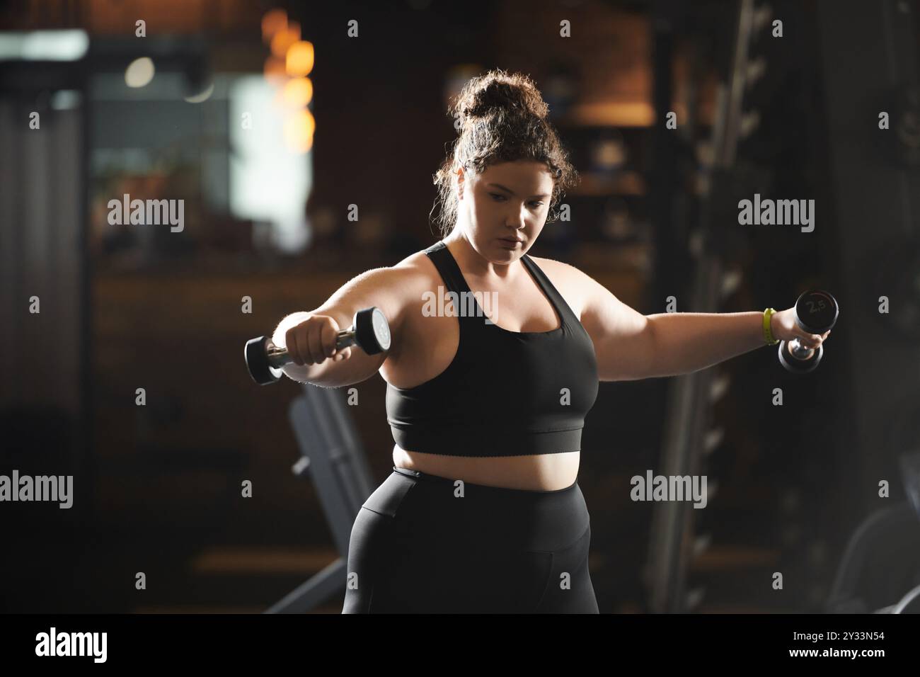 Determined young woman lifts hi-res stock photography and images - Alamy
