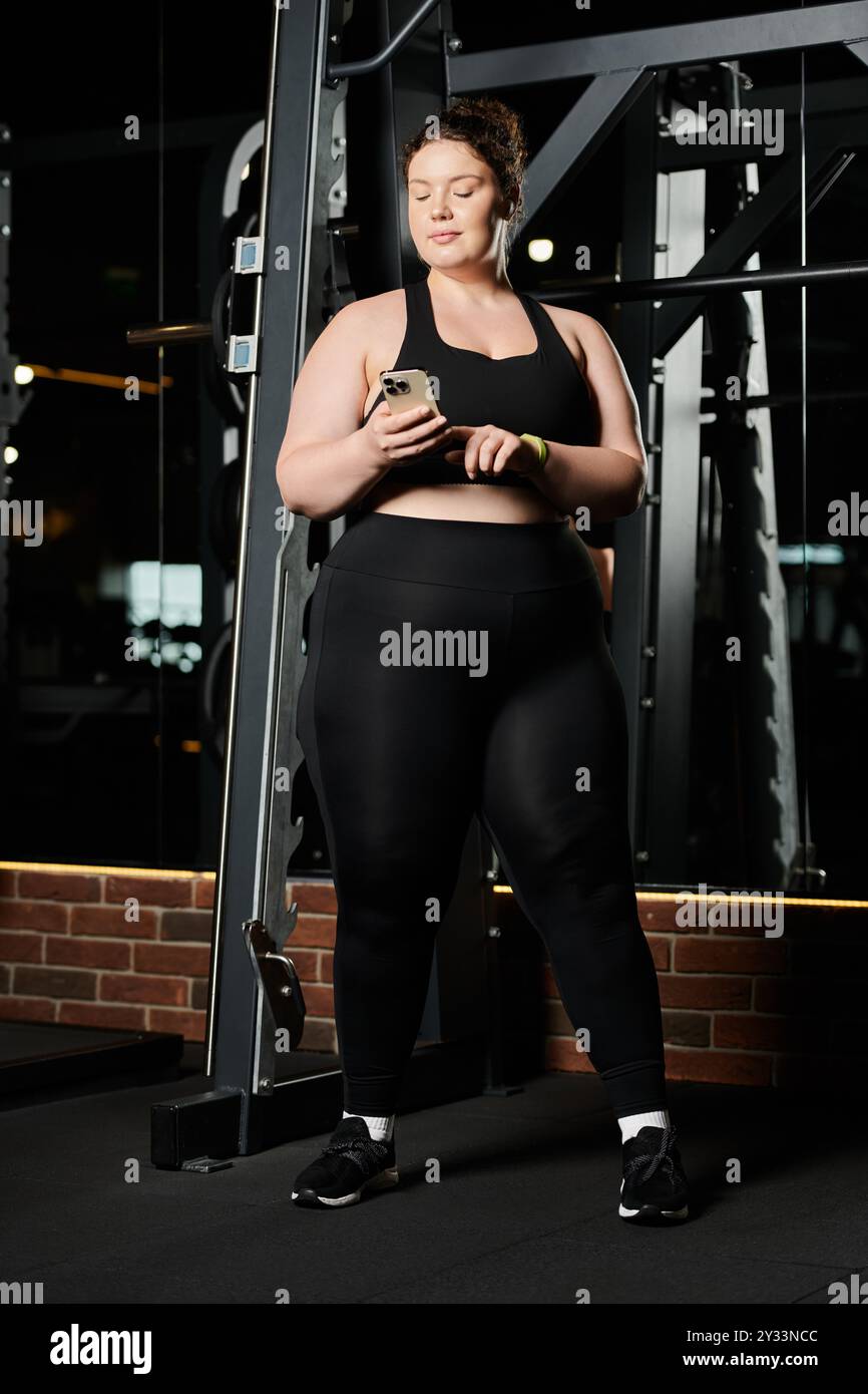 A confident young woman embraces her strength, taking a moment to check ...