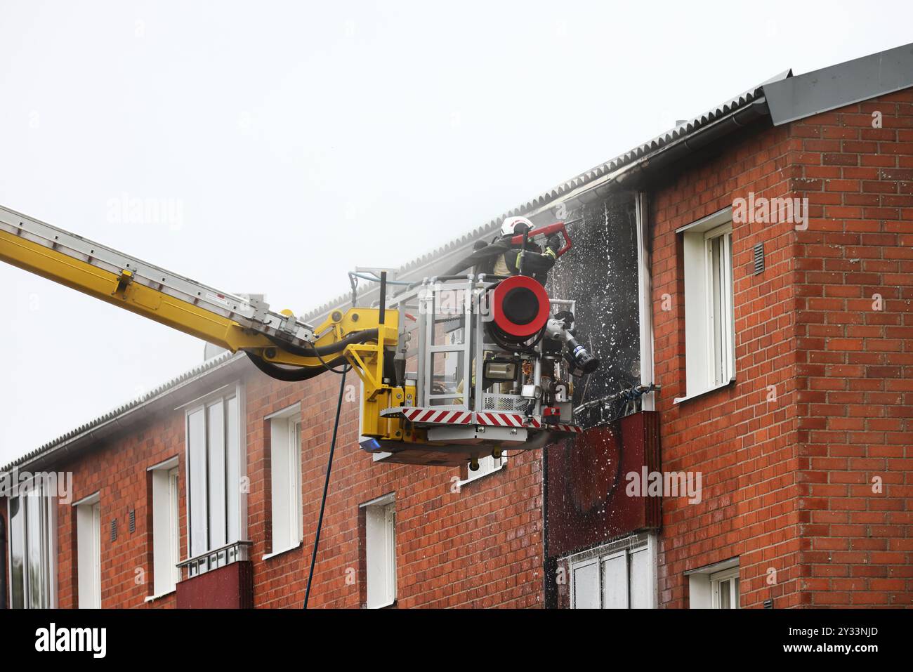 Fire in an aparment building, rescue services at the scene Stock Photo ...