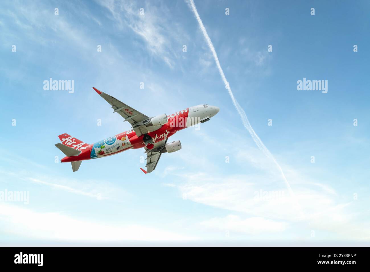 Air Asia Airlines. Boeing 320 flying in the air with blue sky. Travel ...
