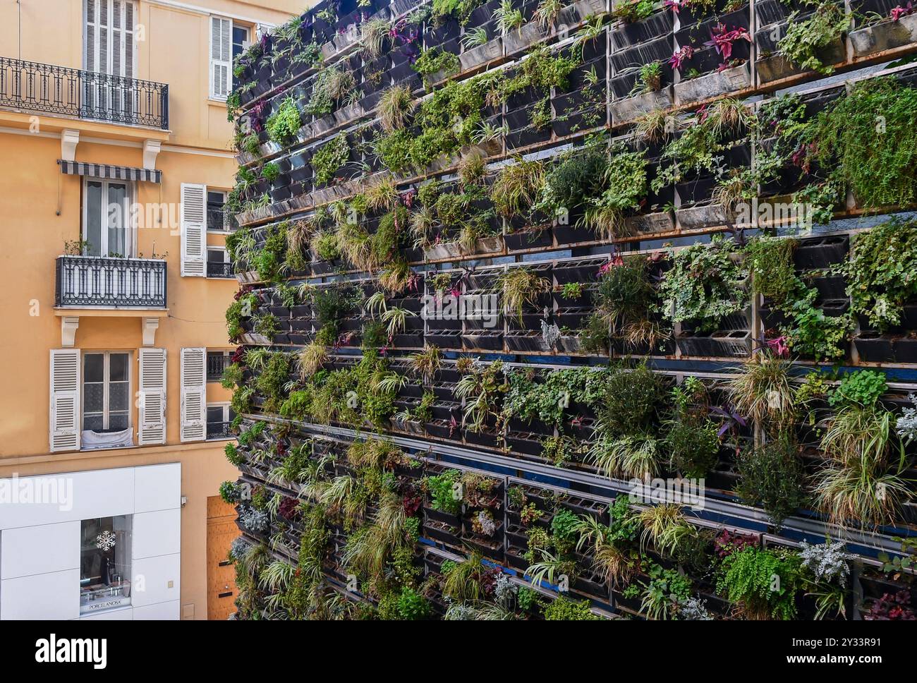 Facade of a building covered with a vertical garden in the centre of ...