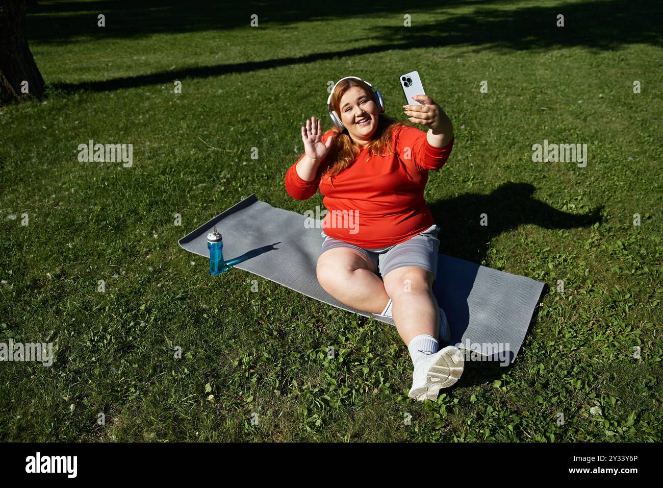 Happy plus size woman exercises and captures a fun moment in the park ...
