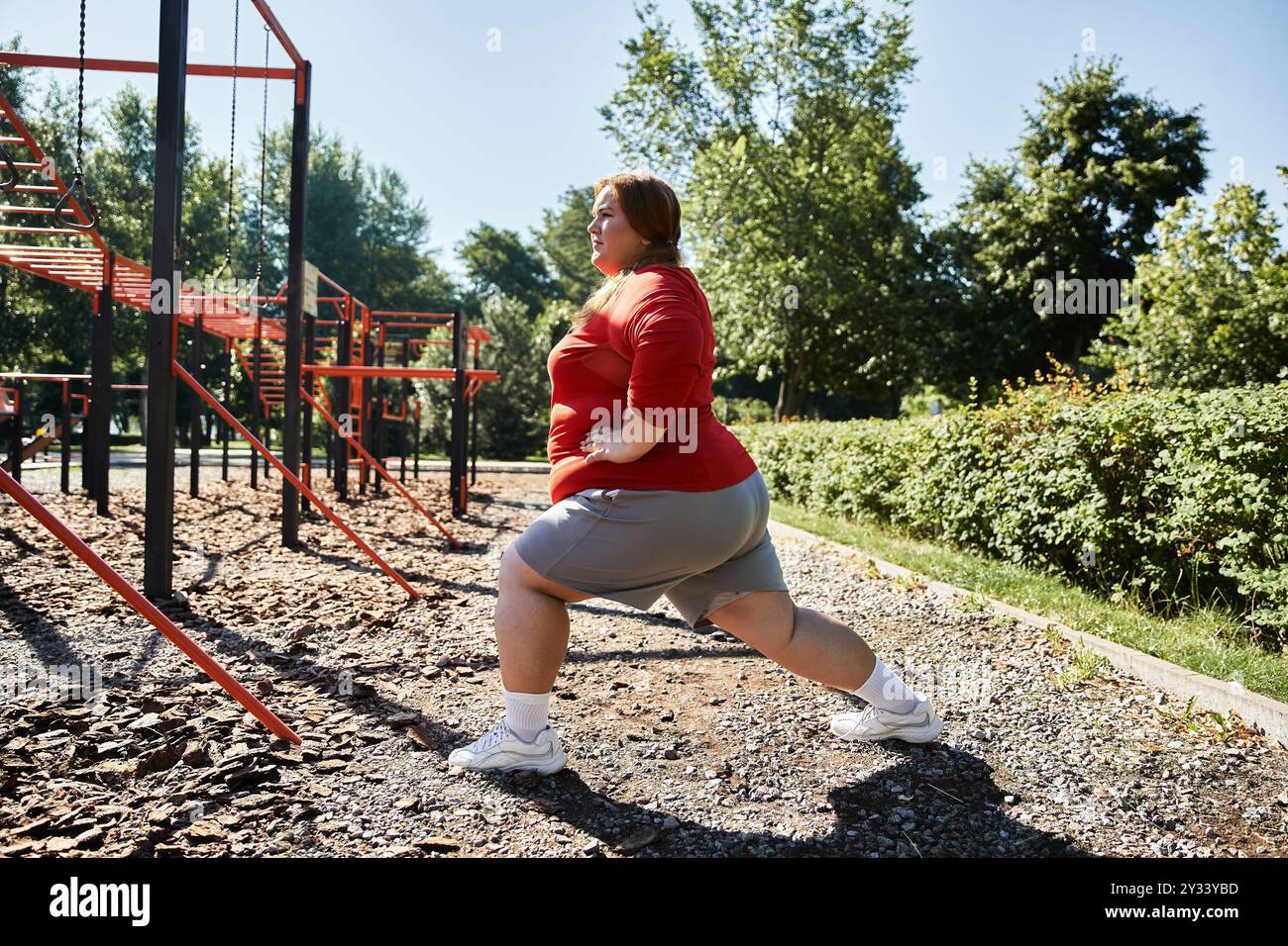 A joyful plus size woman exercises outdoors, embracing the fresh air ...