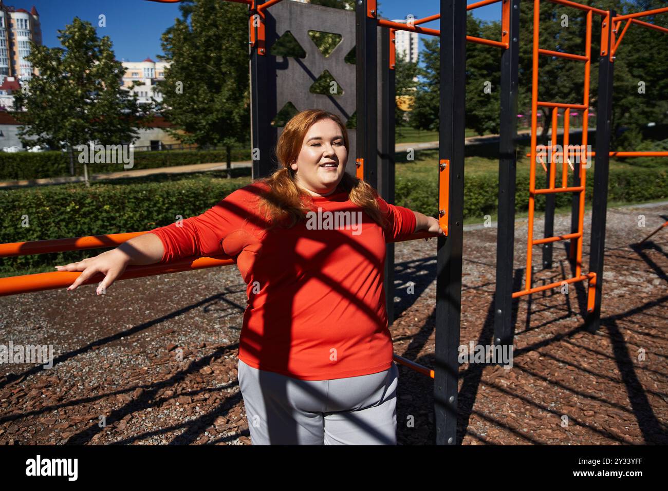 A confident woman exercises in a vibrant park under the sun Stock Photo ...