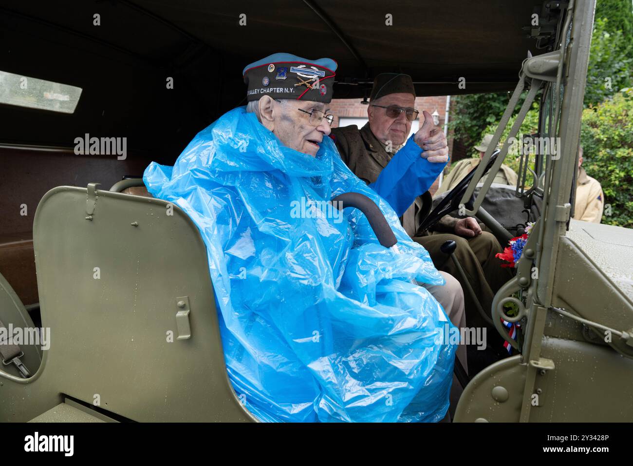 World War II veteran Kenneth Thayer flashes a thumbs up from a jeep ...
