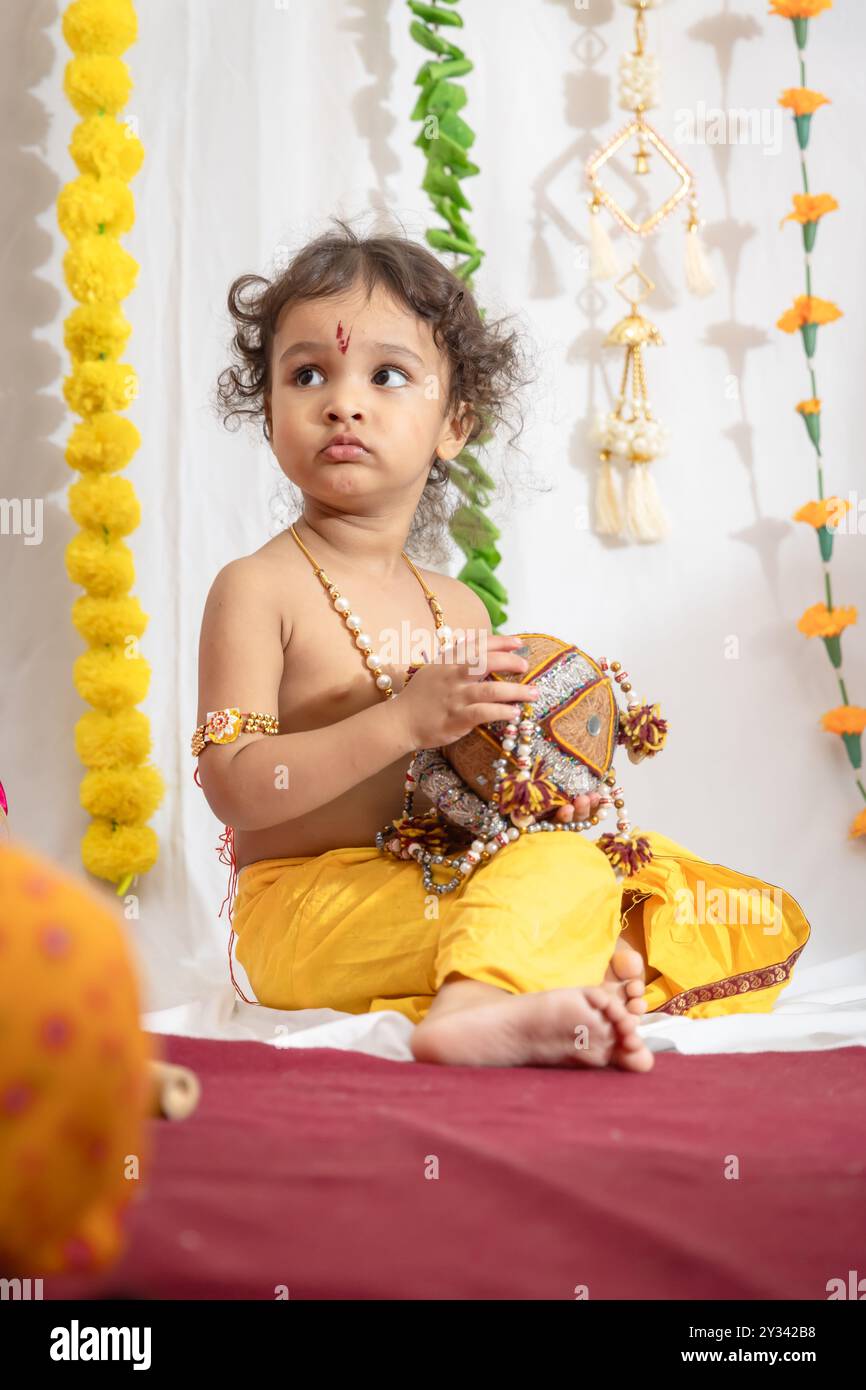 little indian baby boy in holy hindu god kirshna attire at indoor Stock ...