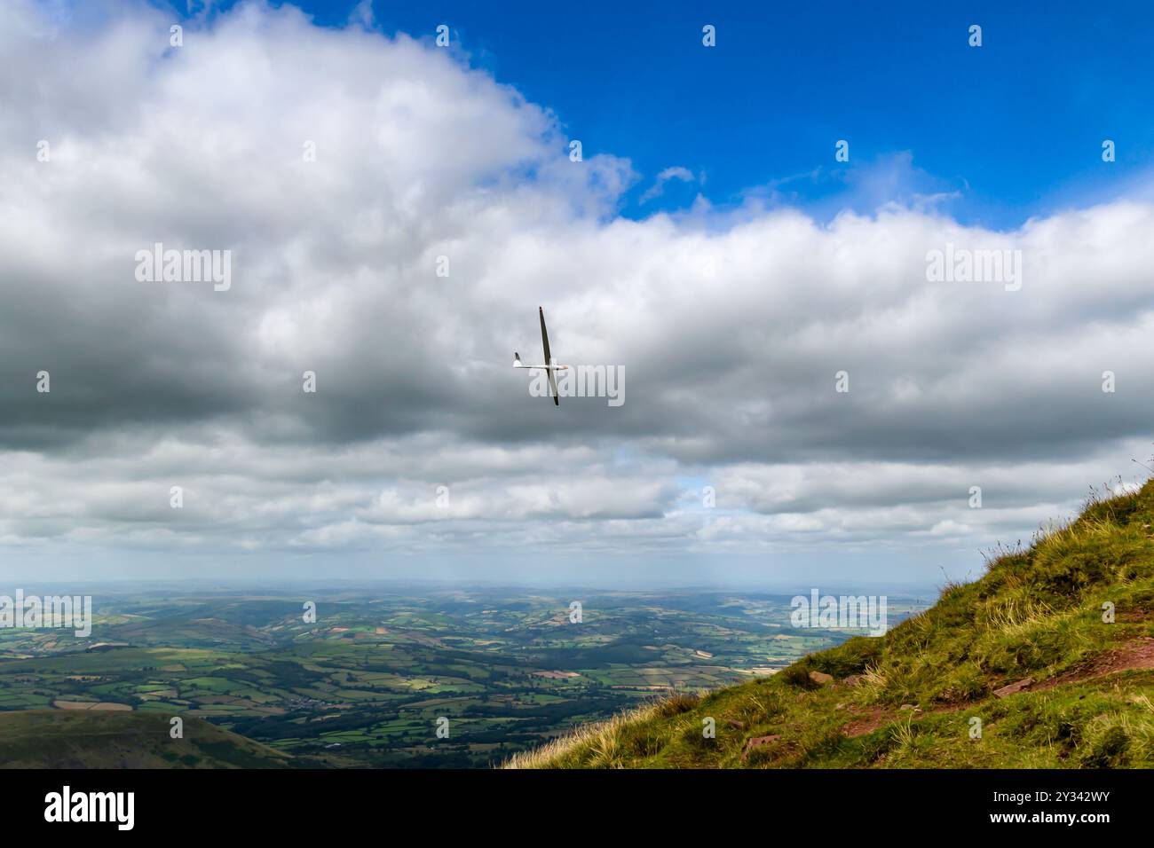 Fixed wing glider soaring around Pen-y-Fan in the Brecon Beacons, Wales ...