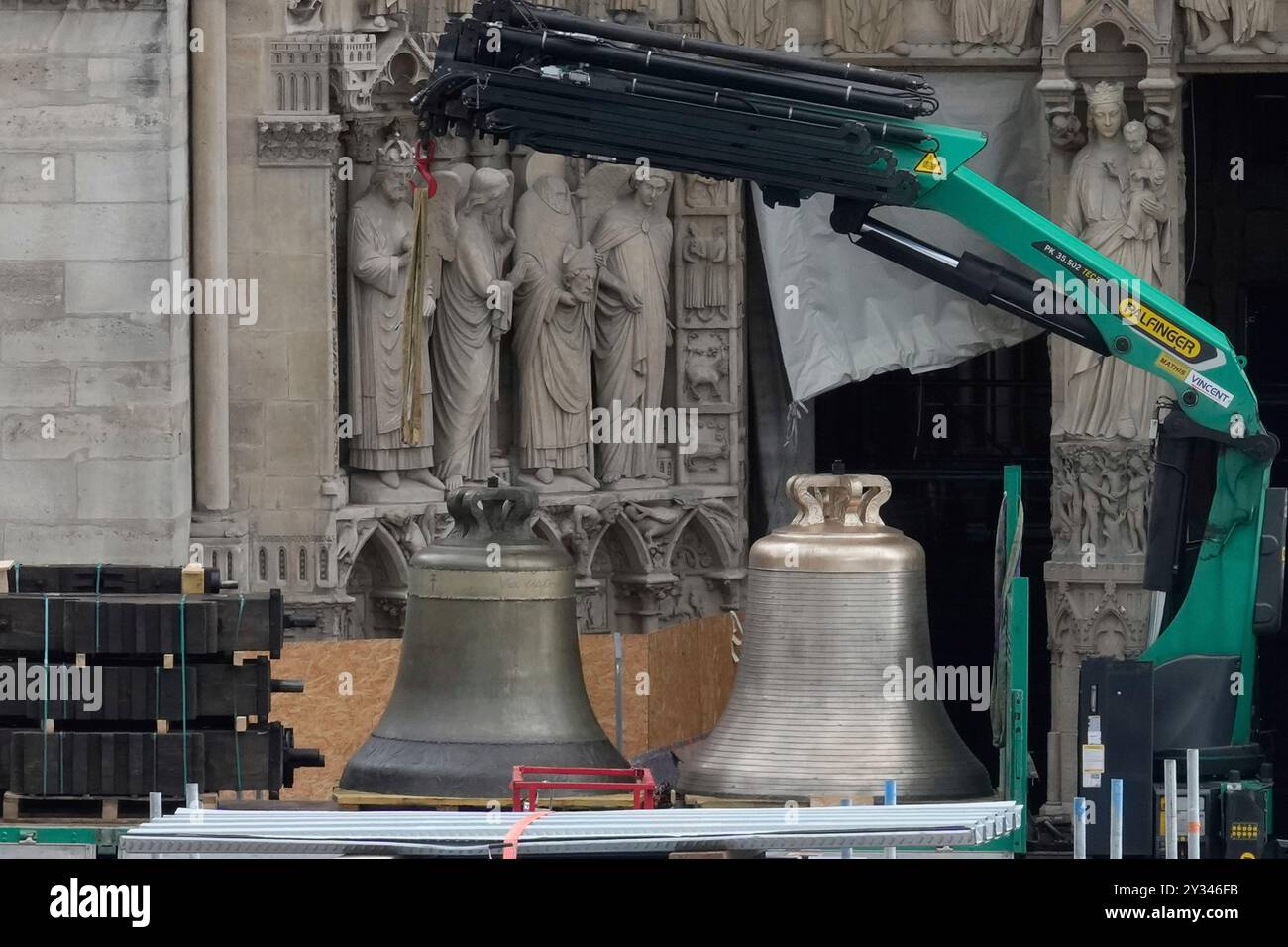 A truck carrying bells is parked outside Notre-Dame de Paris cathedral ...