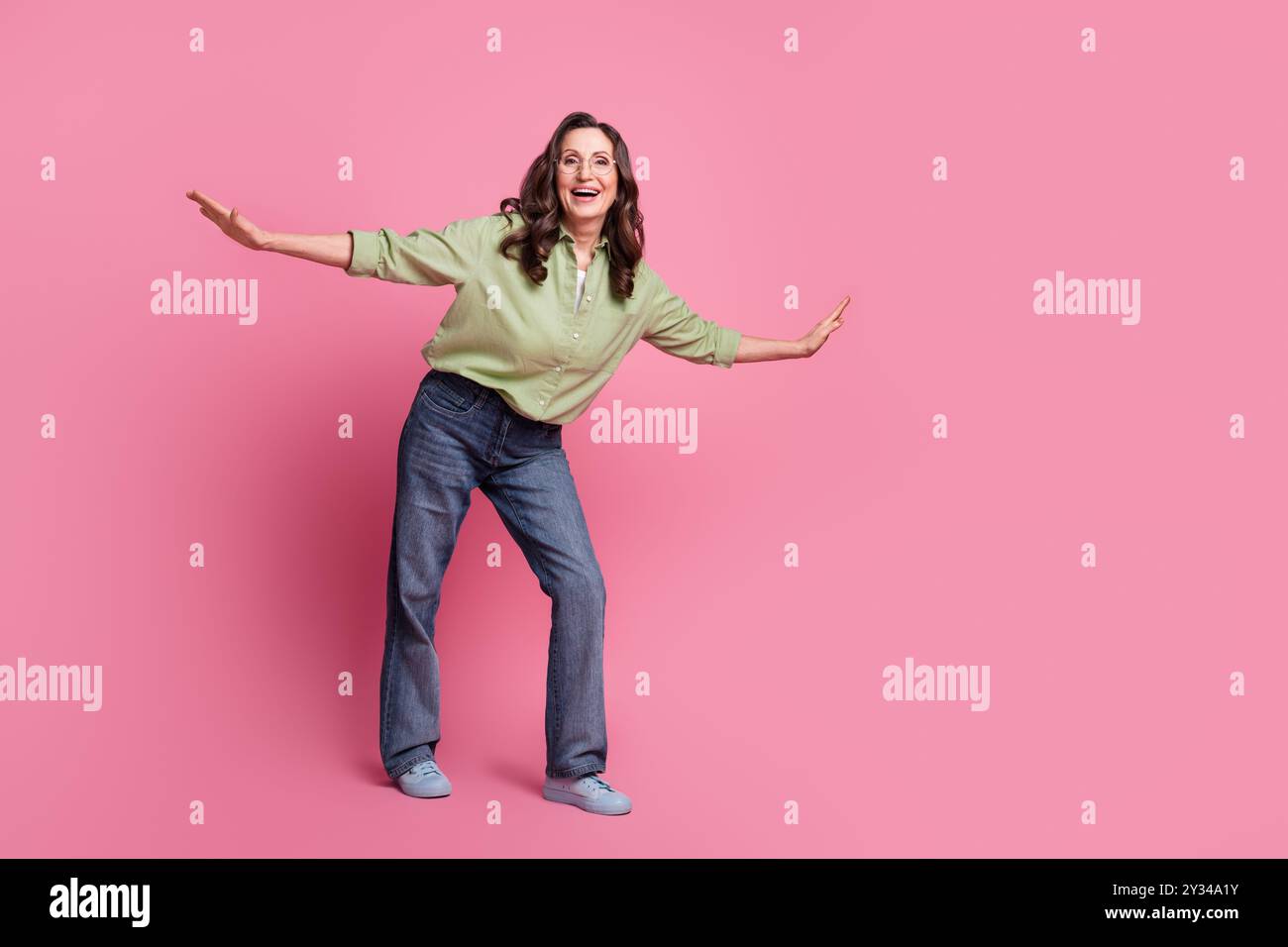 Full length photo of elegant grandmother woman in khaki shirt and jeans ...