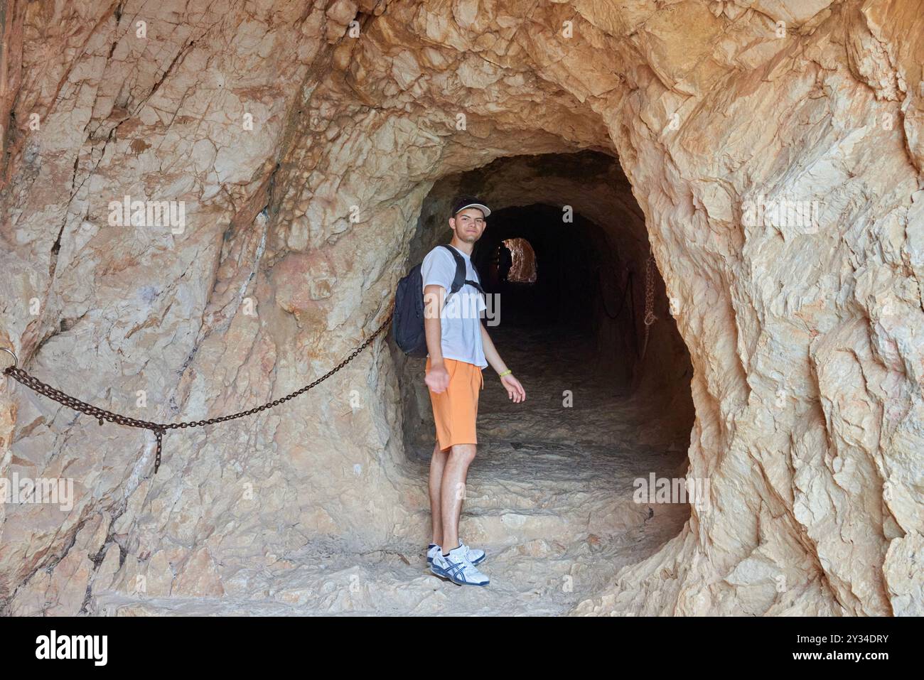 Adventurous Young Explorer Stands at Mysterious Mountain Cave Entrance ...