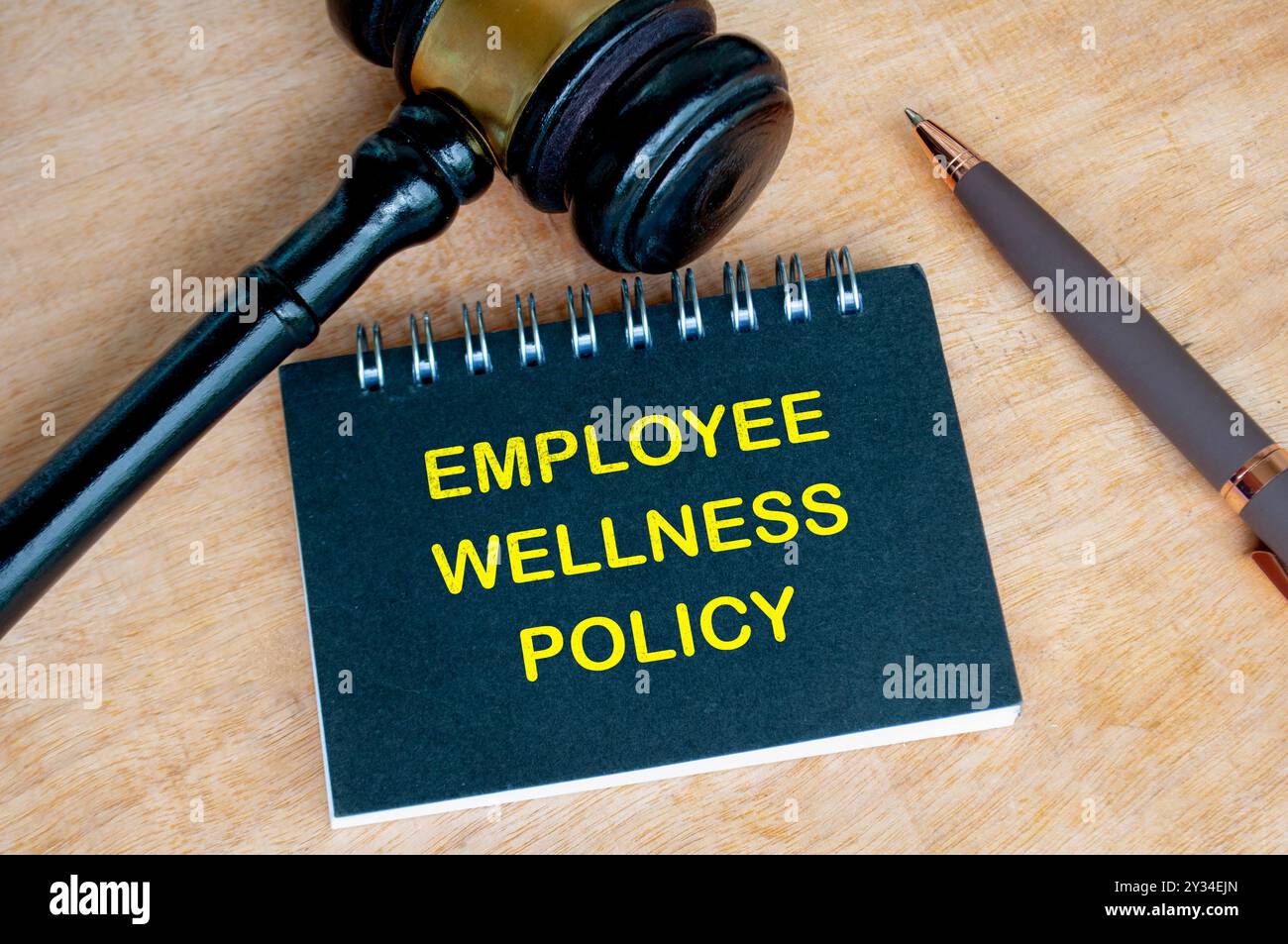 Top view of employee wellness policy text with gavel and pen background ...