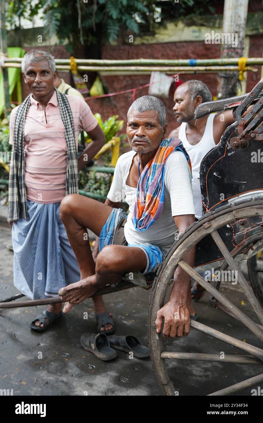 A rickshaw puller navigates the bustling streets of Kolkata, showcasing ...