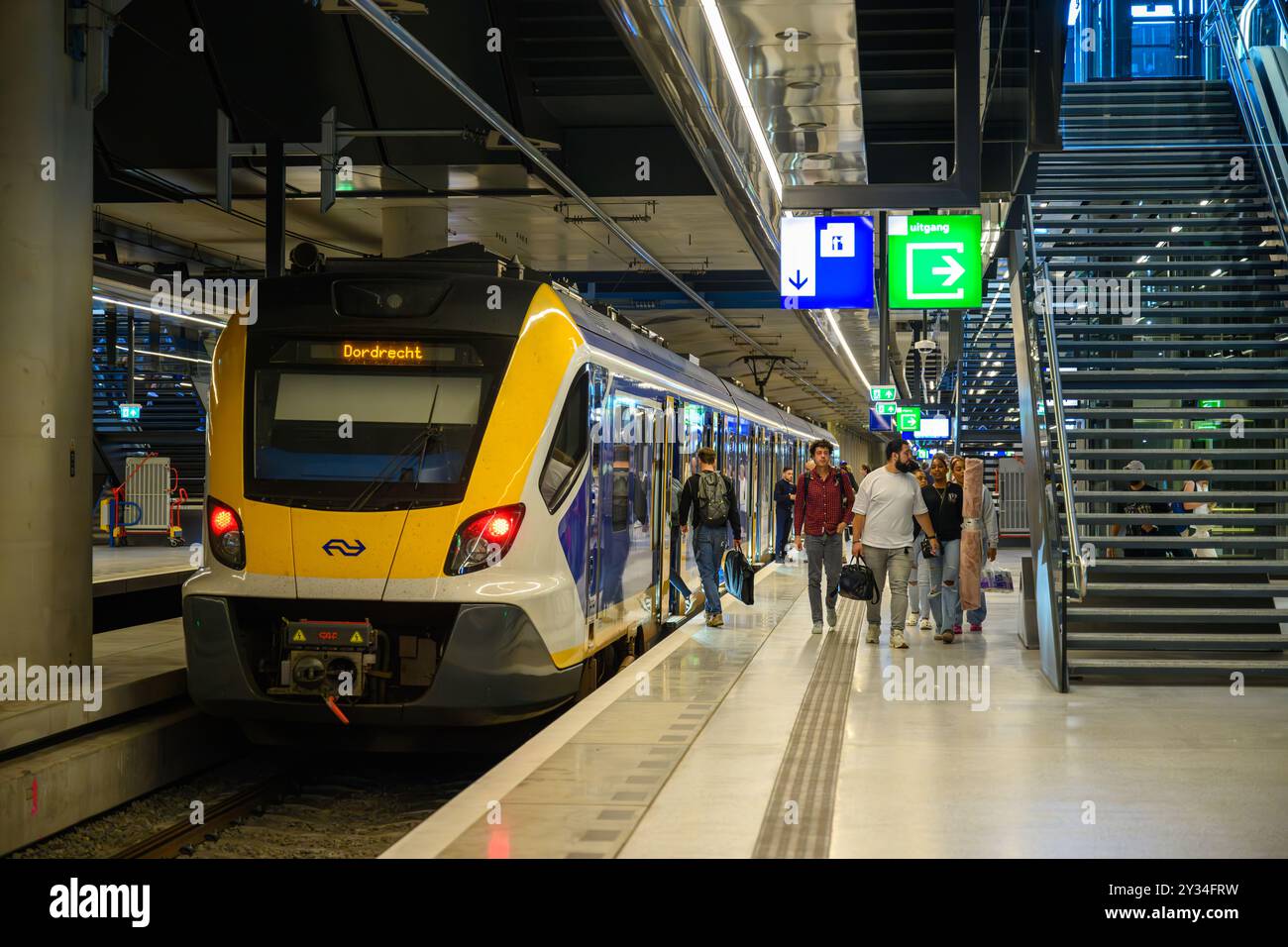 Passengers boarding an NS Sprinter train at Delft Railway Station ...