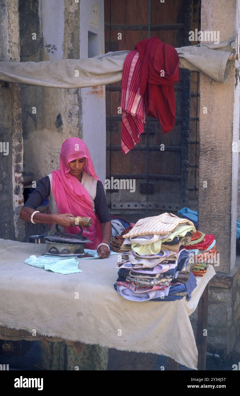 a women at her Laundry homework in the City of Jaipur in the Province of Rajasthan in India ...