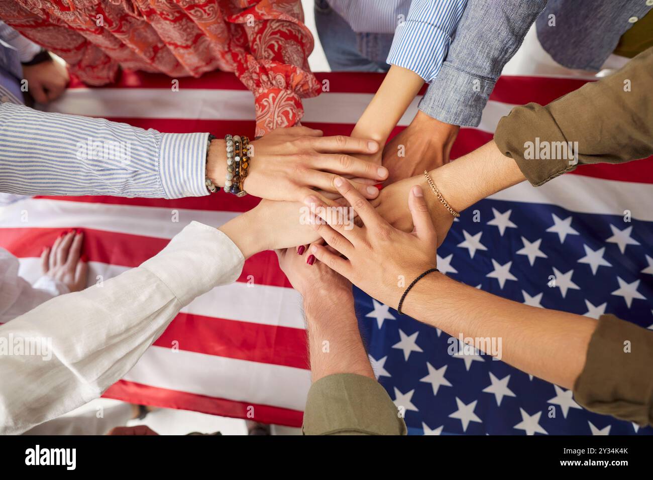 Diverse people hands coming together over american flag, symbolizing ...