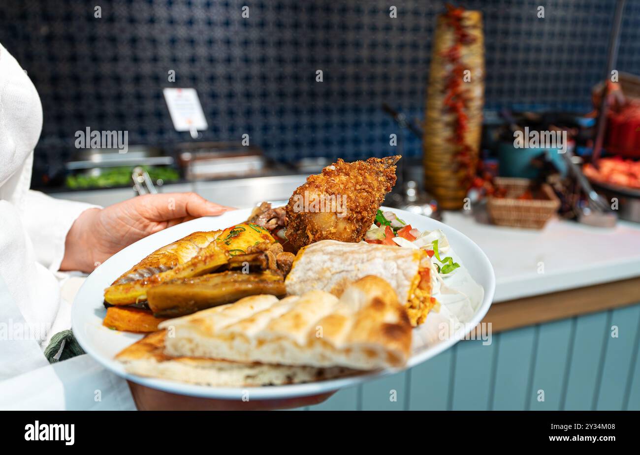 Woman holding a plate full of food. All inclusive concept Stock Photo ...