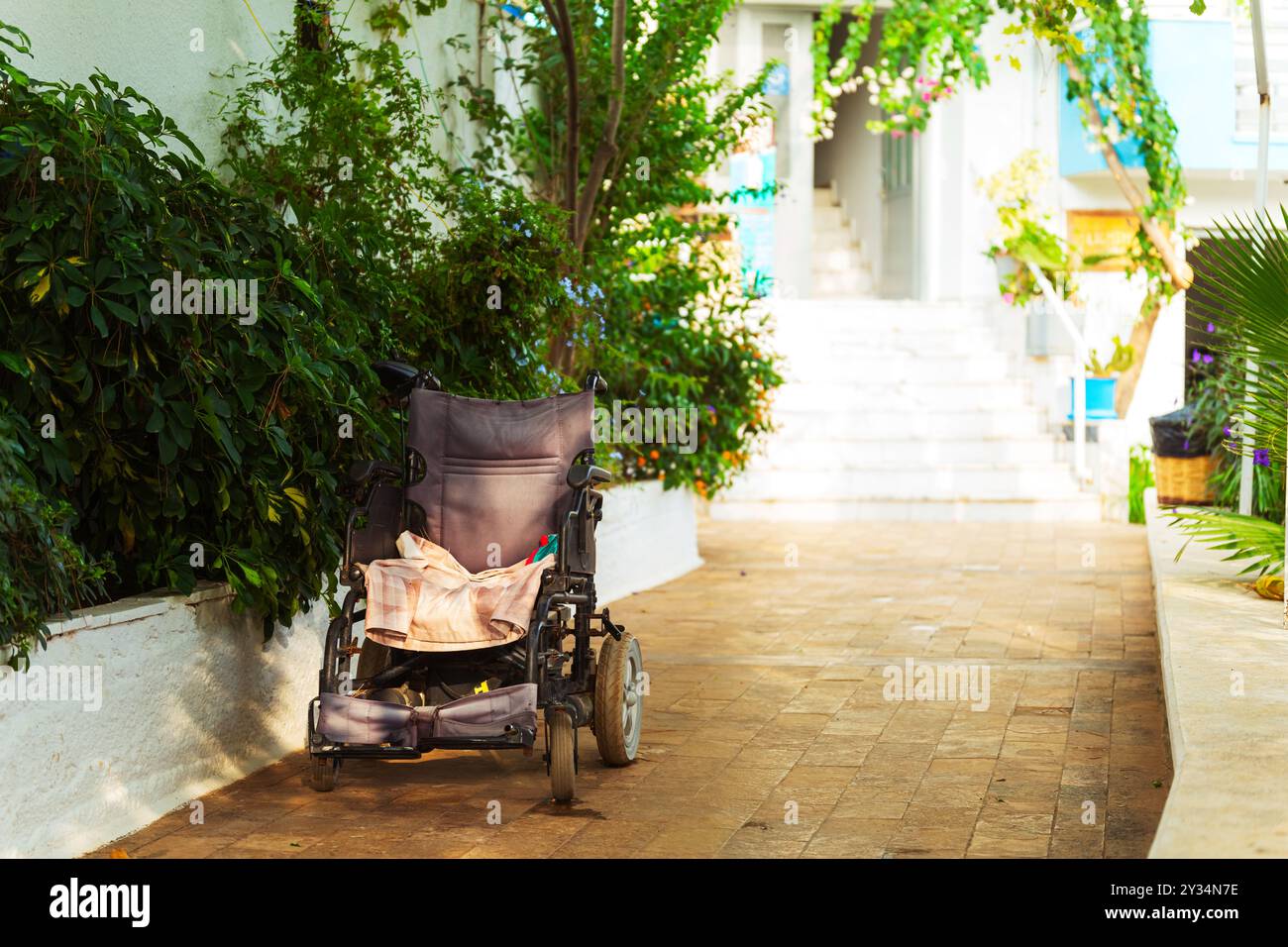 wheelchair parked directly on the garden path Stock Photo - Alamy