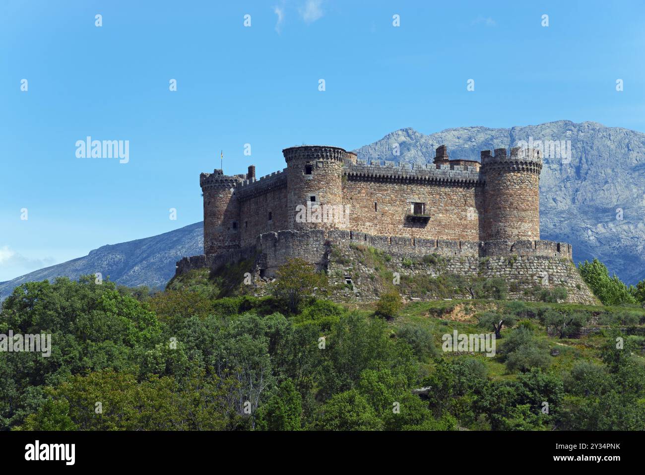Medieval castle on a hill surrounded by nature with majestic mountains ...