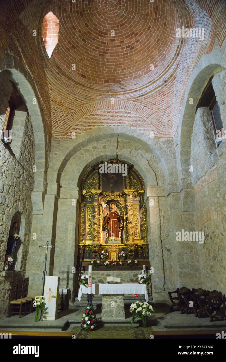 Interior of a church with magnificent altar, stone arches and religious ...