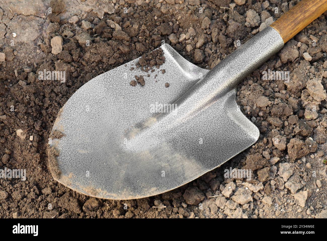 Metal shovel on soil outdoors, closeup. Gardening tool Stock Photo - Alamy
