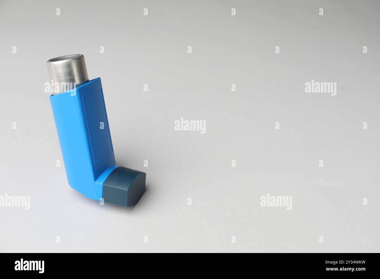 Asthma inhaler on light grey background, space for text Stock Photo - Alamy