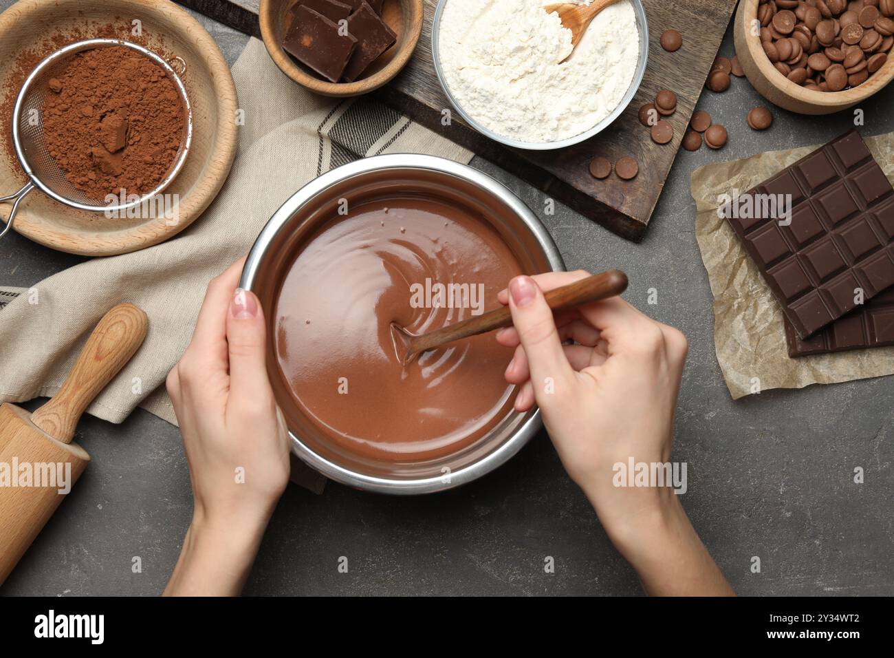 Woman making chocolate dough at grey table, top view Stock Photo - Alamy