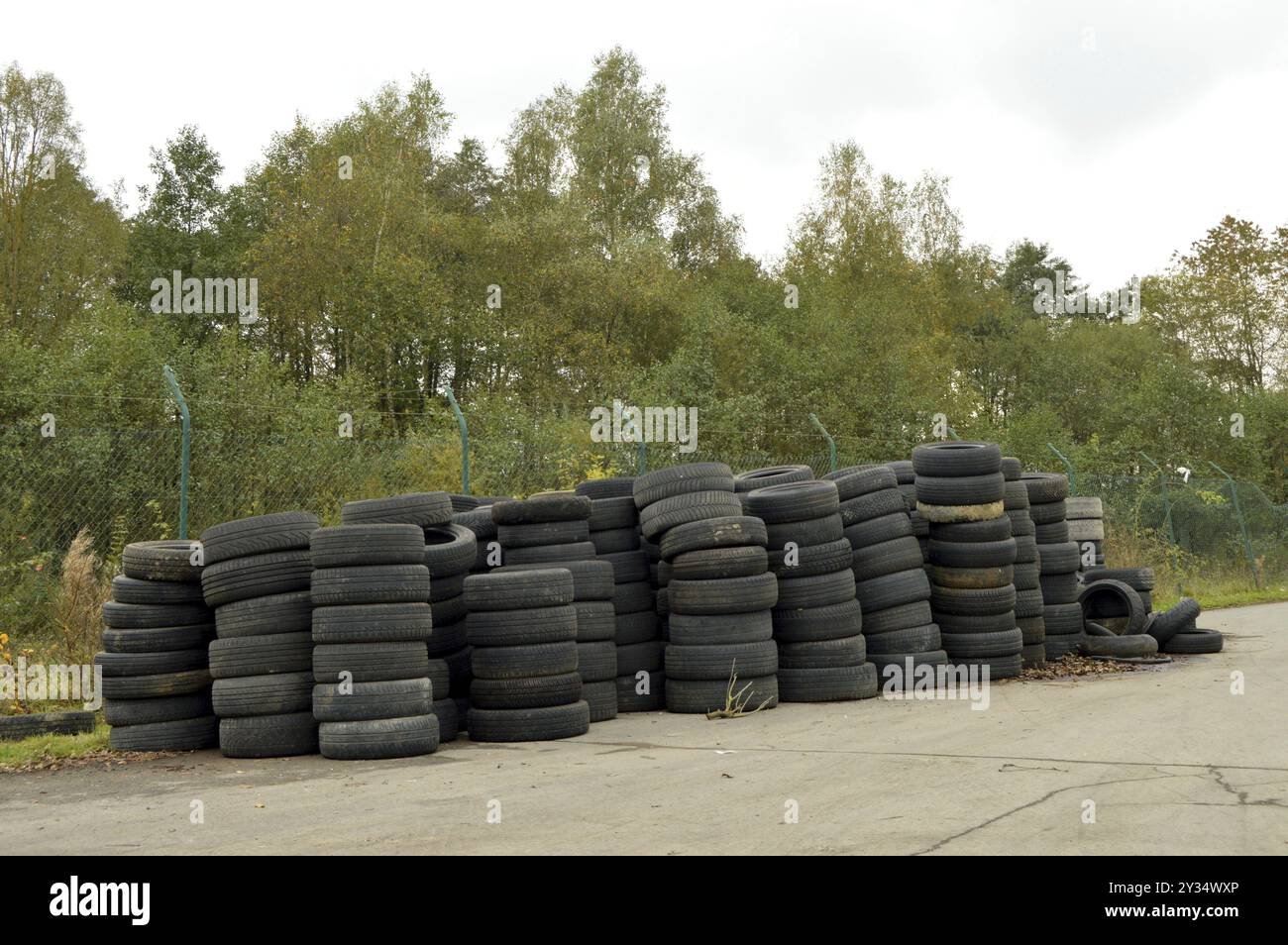 Heap of old tires user in a center of recycling Stock Photo - Alamy
