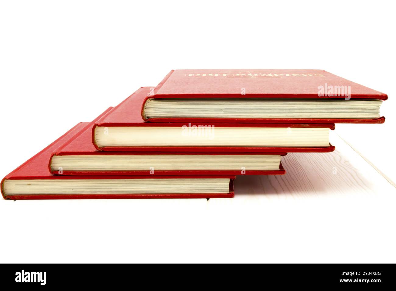 Red books flip over on a floor with white background Stock Photo - Alamy