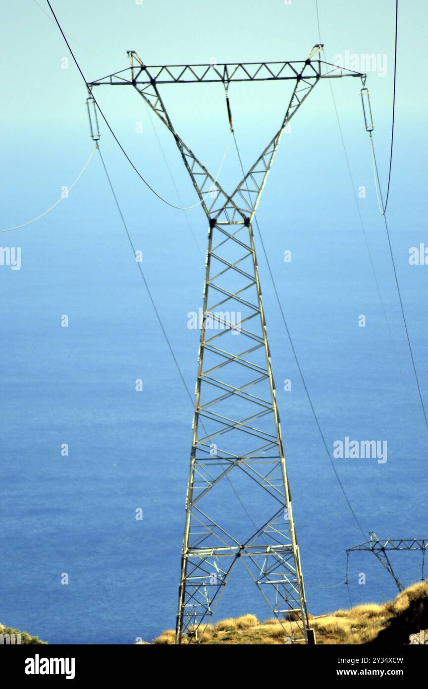 A high-voltage electric pole on the background of ocean Stock Photo - Alamy