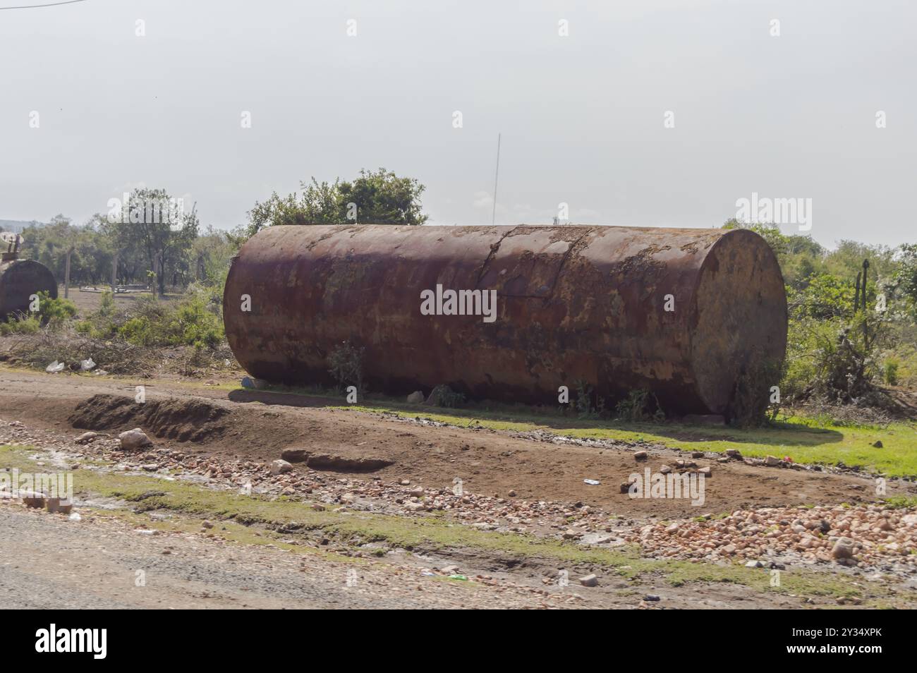 Old rusty tanker on a dirt road from Masai Mara Park in northwestern ...