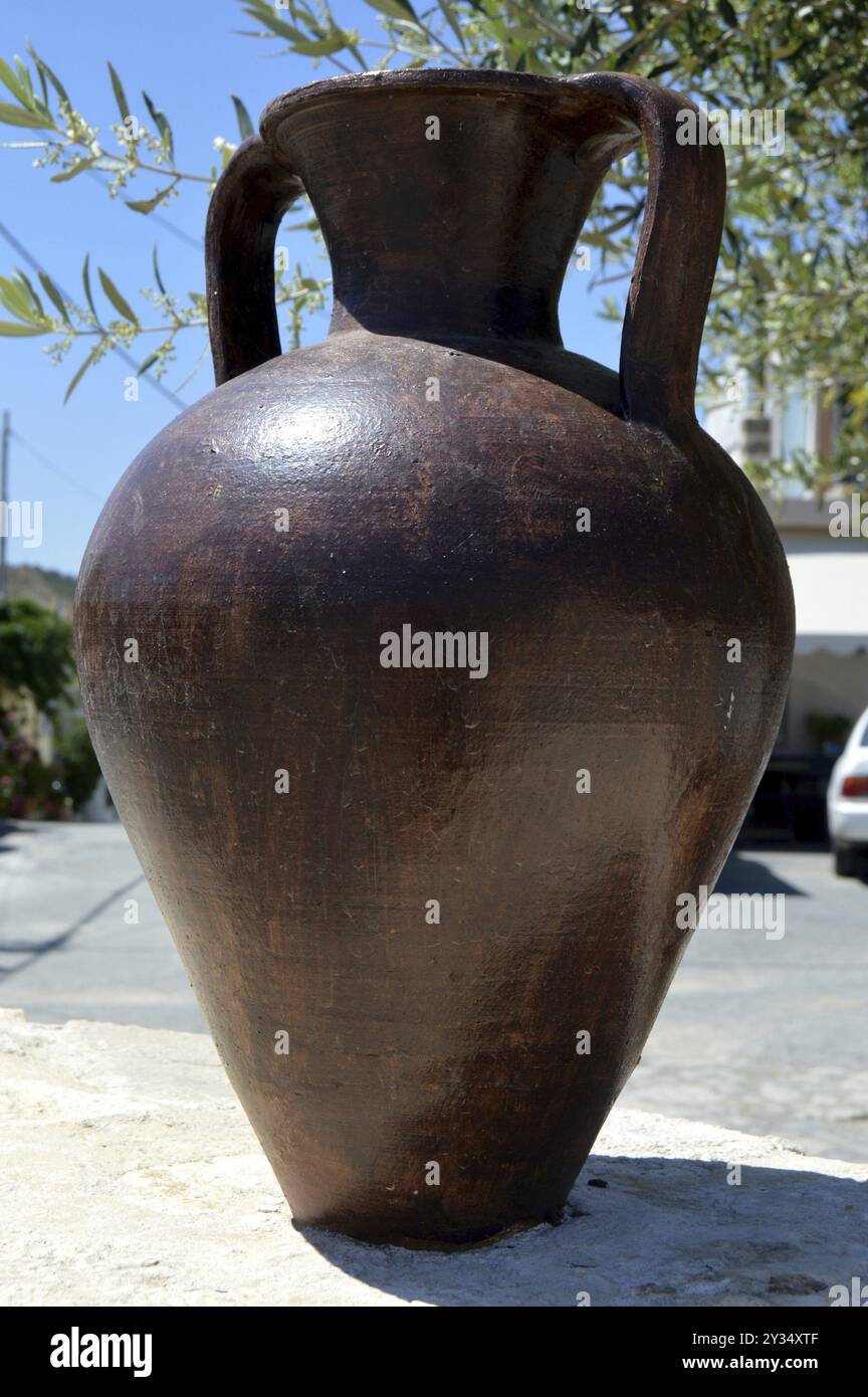 An amphora of brown color on a wall in stones Stock Photo - Alamy