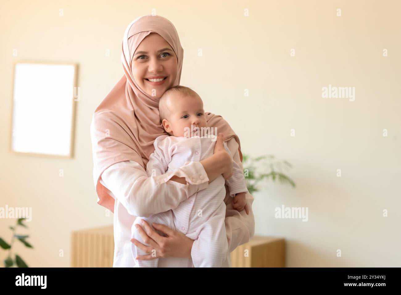 Happy Muslim mother in hijab with cute little baby at home Stock Photo ...