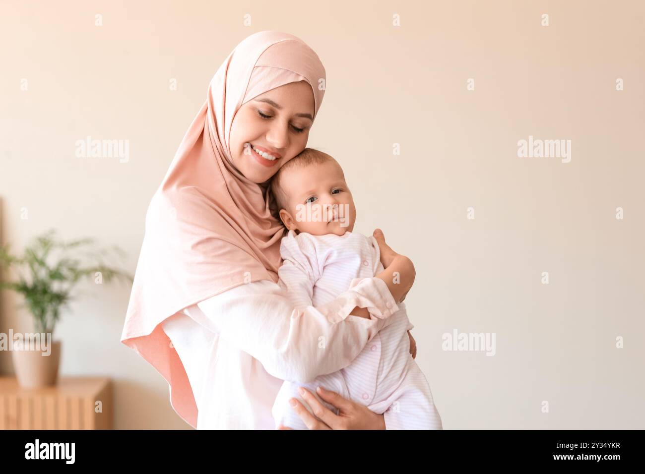 Happy Muslim mother in hijab with cute little baby at home Stock Photo ...