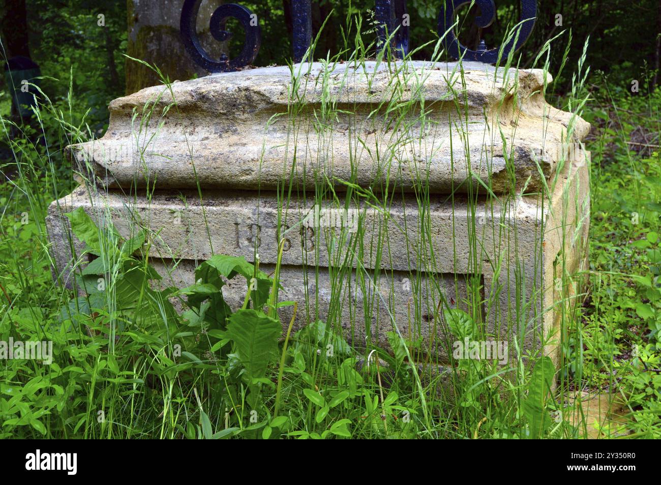 Old base of stone crucifix with one dates Stock Photo - Alamy