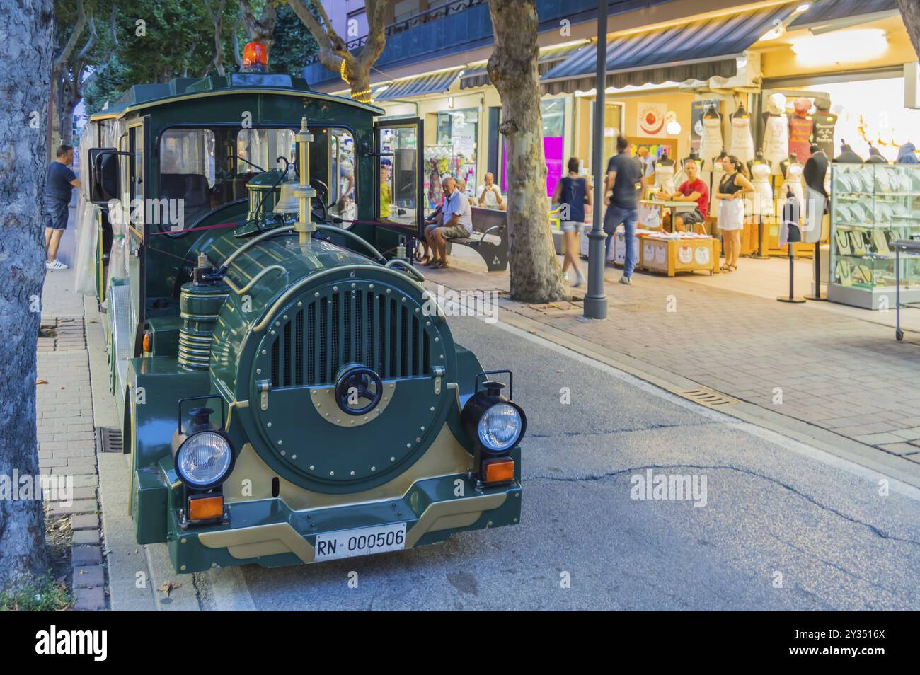 Locomotive of a small tourist train in the streets of Igea Marina near ...