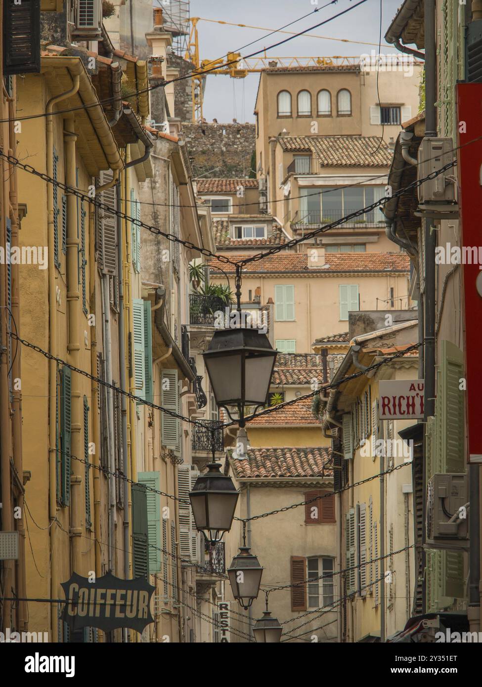A narrow, charming alley in an old town, lined with tall buildings with ...