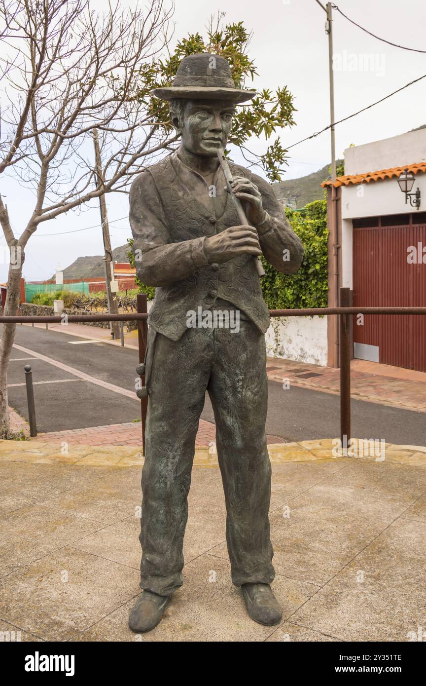 Bronze statue of a flute player in traditional Canarian clothes in ...