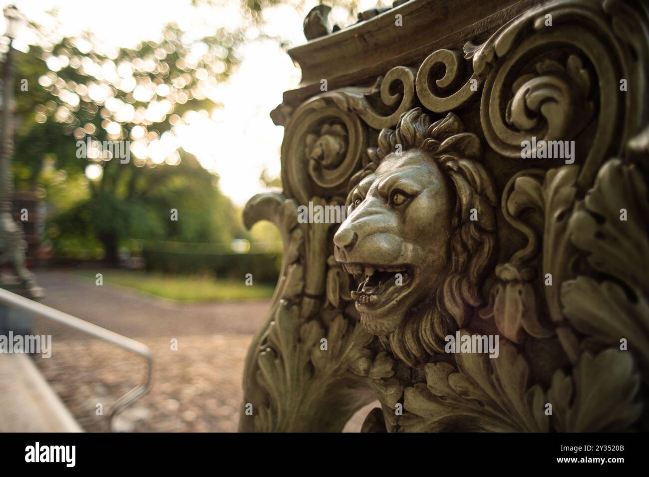 Old, metal sculpted lion head statue. Close up shot of head and mane ...