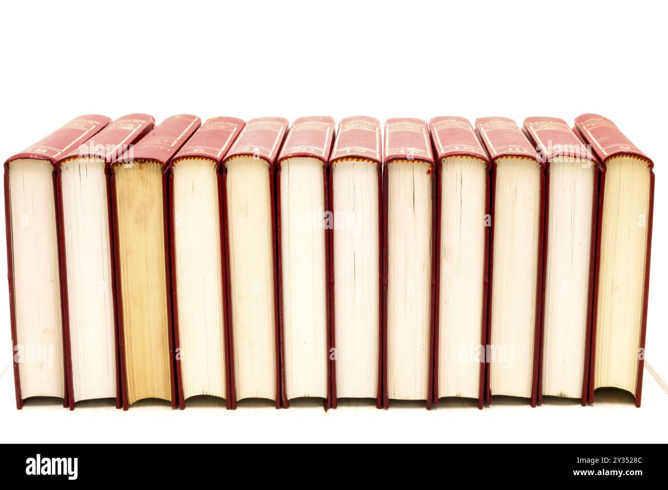 Red books flip over on a floor with white background Stock Photo - Alamy