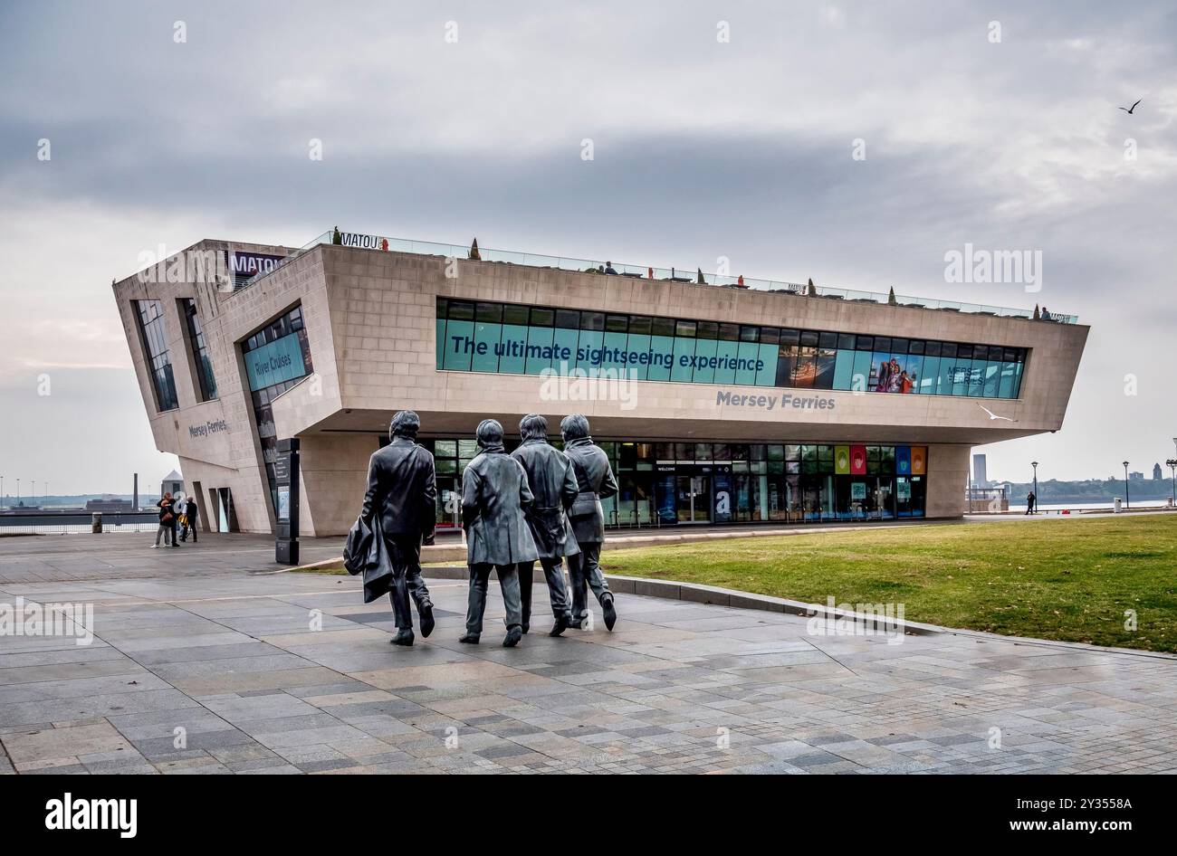 This image is the statue of the Liverpool music group the Beatles who ...