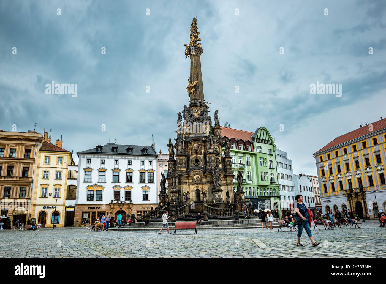 The Holy Trinity Column in Olomouc city with people walking around, and ...