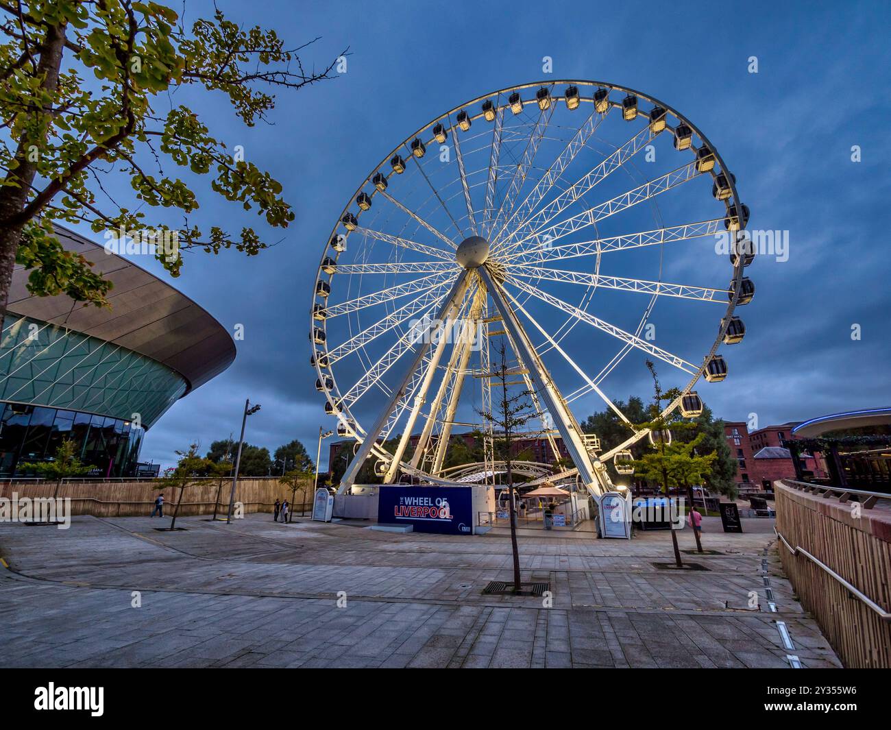This colourful night street scene image of the Liverpool Ferris Wheel ...
