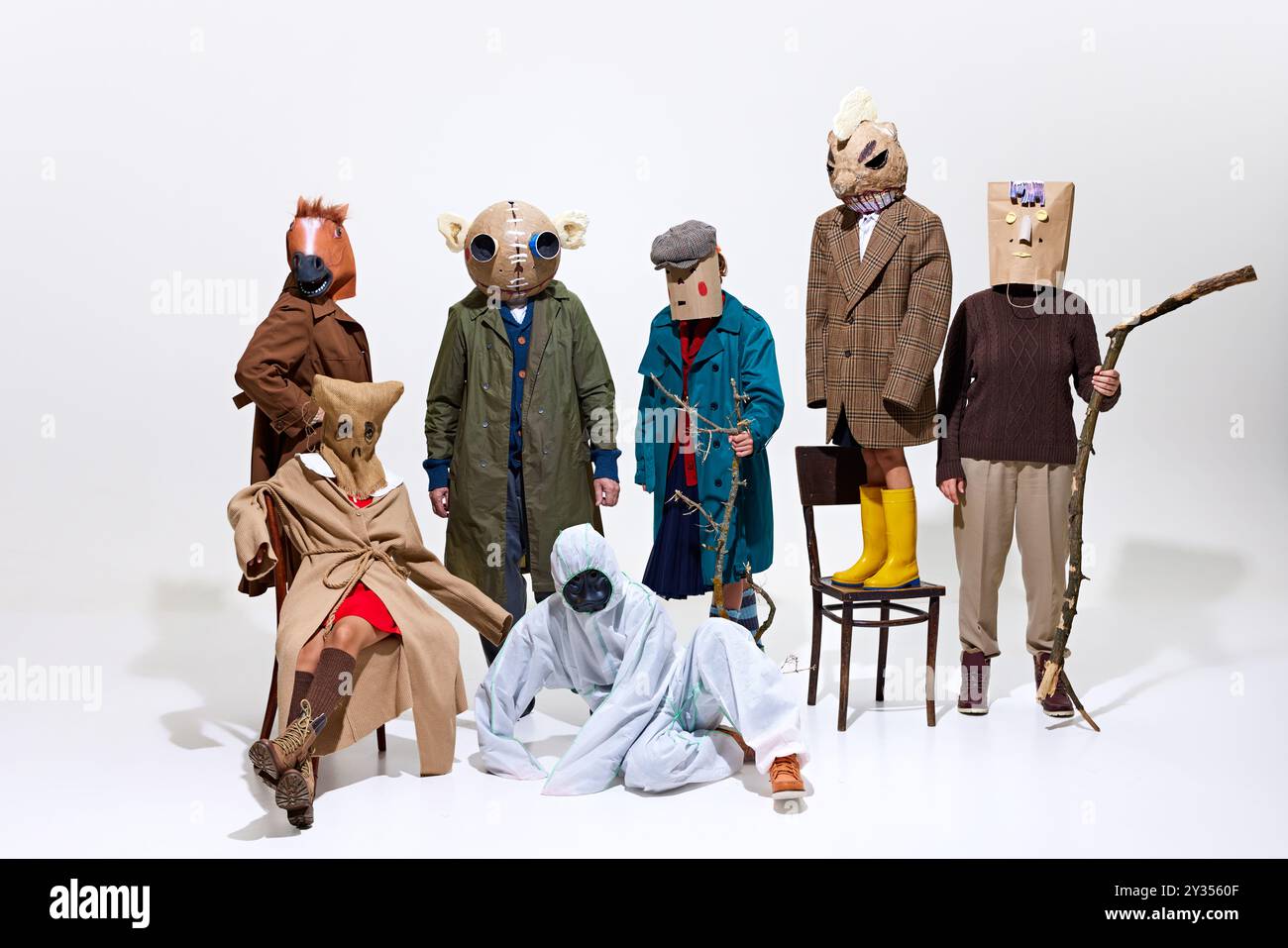 Four people in hauntingly simple costumes isolated on white background ...